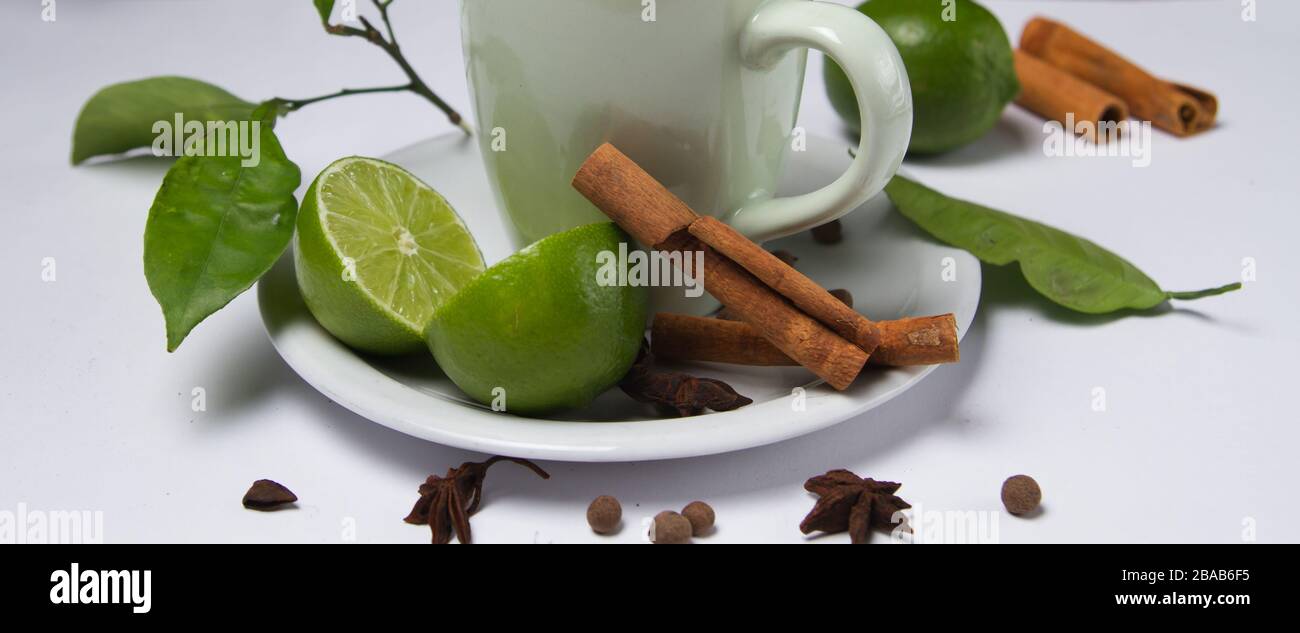 hot lemon tea cup beverage with lemon spices on white table background ...
