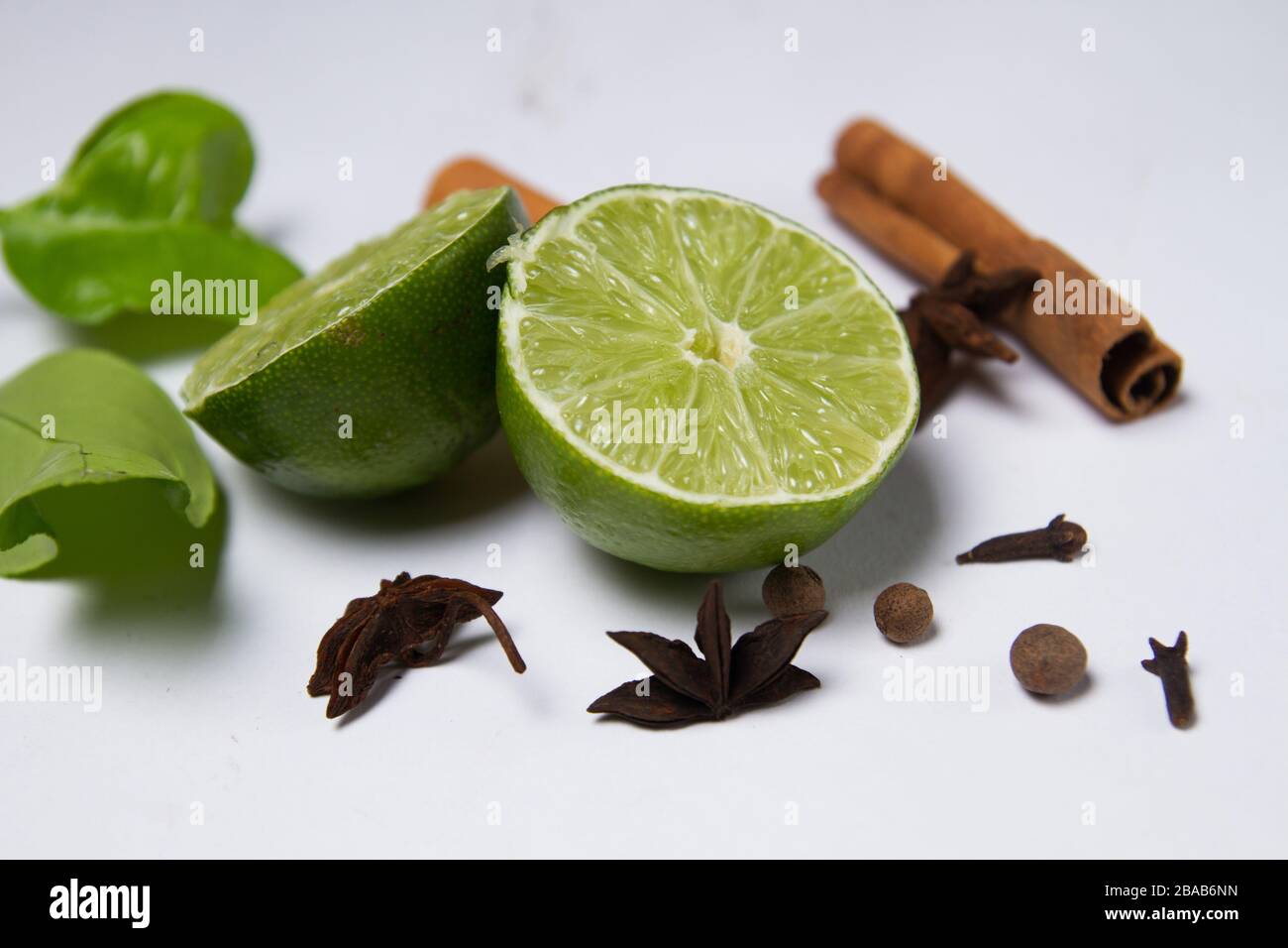 lemon slice and spices on white table black background Stock Photo - Alamy