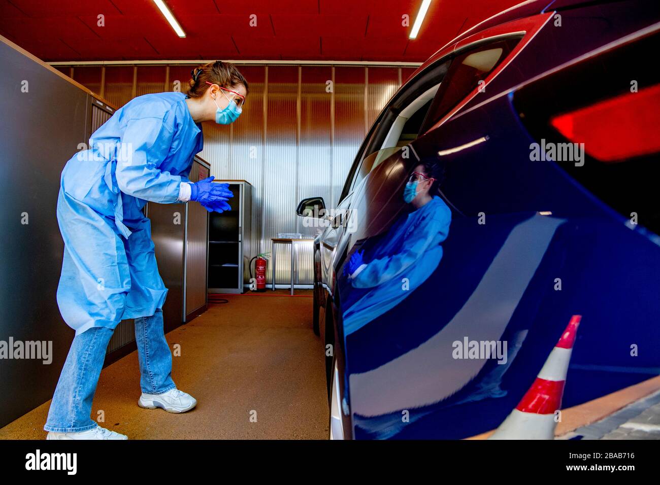 A nurse prepares to give a COVID-19 Coronavirus test to the people in ...