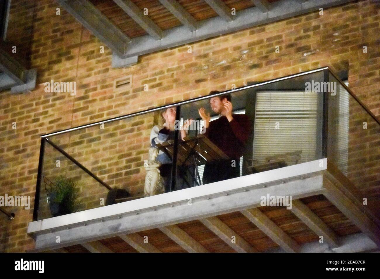 People in Wapping Wharf, Bristol, come out onto their balconies to join ...