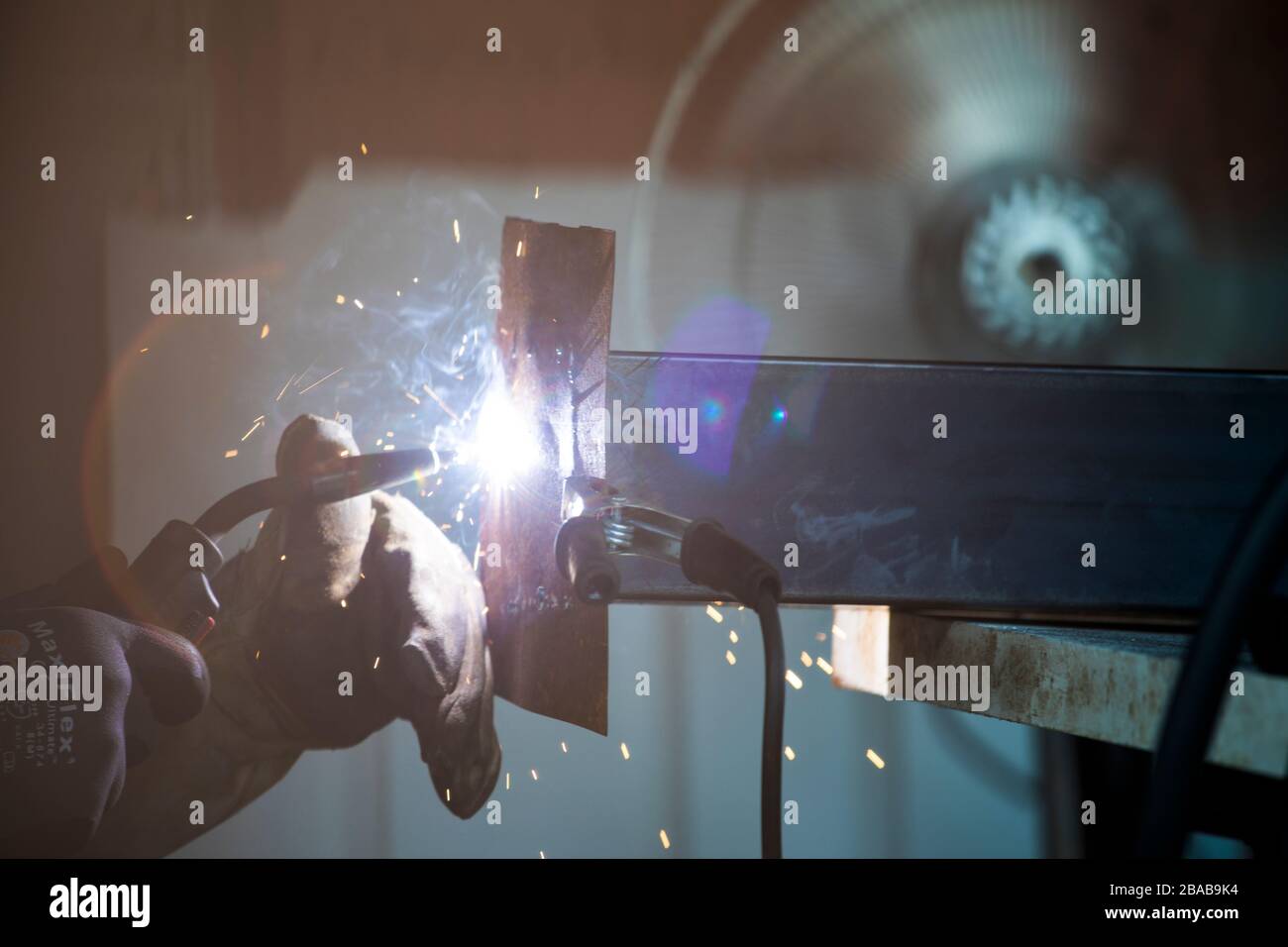 Detailed side view of welder working in shop Stock Photo - Alamy