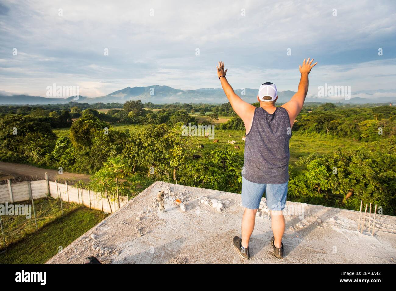 Man praising and worshipping God early in the morning from rooftop ...