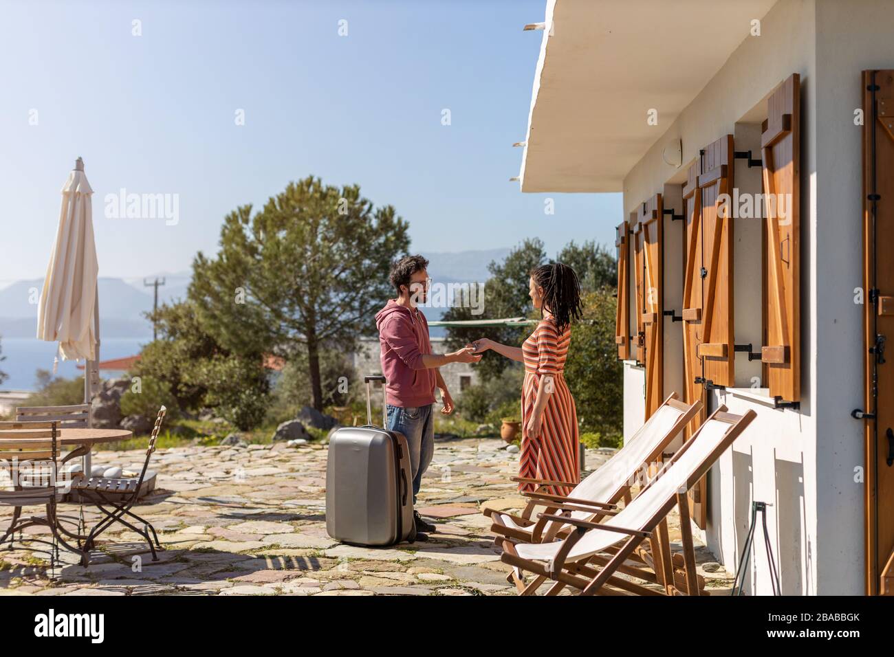 Welcoming guest hi-res stock photography and images - Alamy