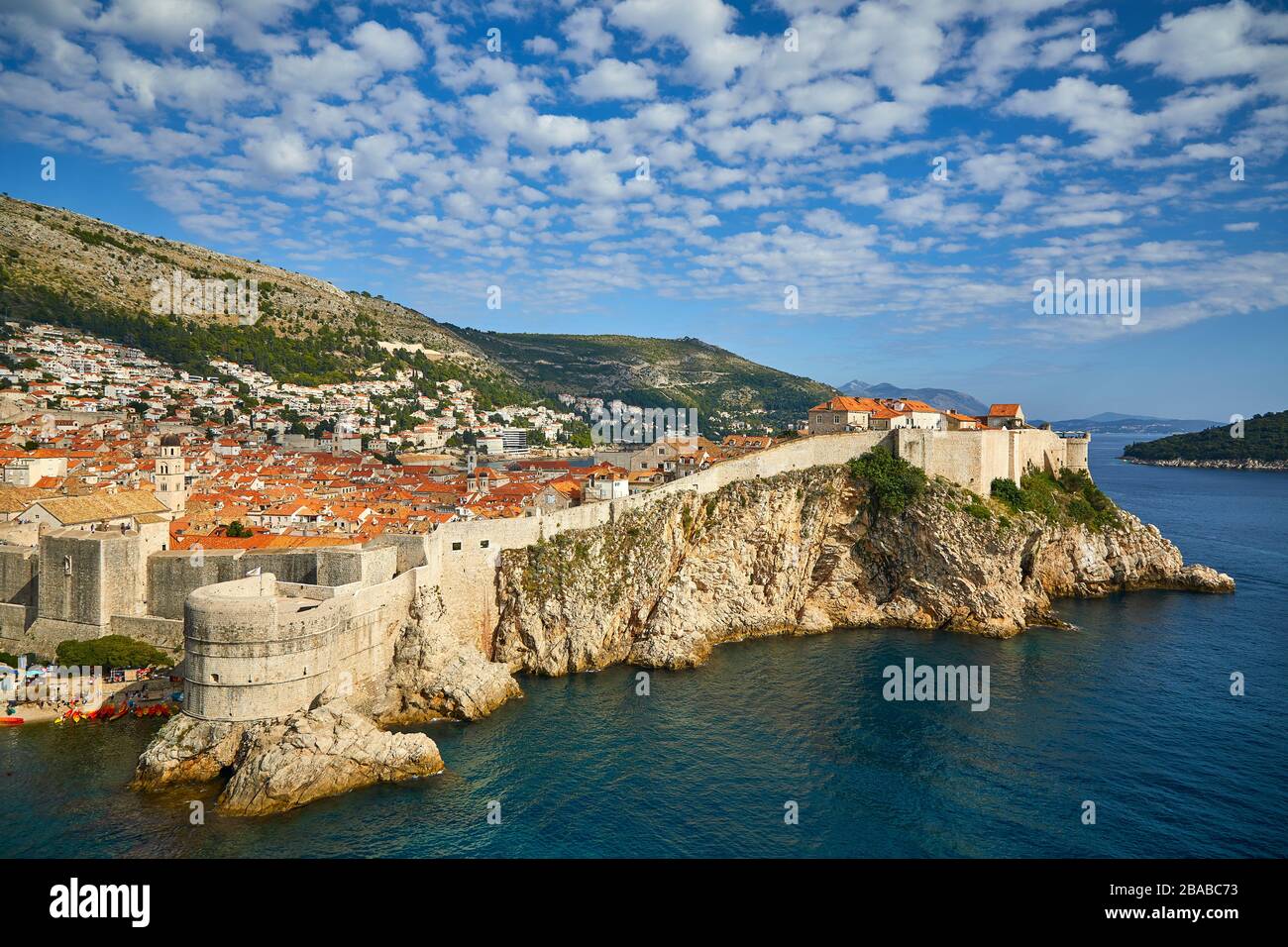 Medieval walls surround the Old Town of Dubrovnik, Croatia as it sits ...
