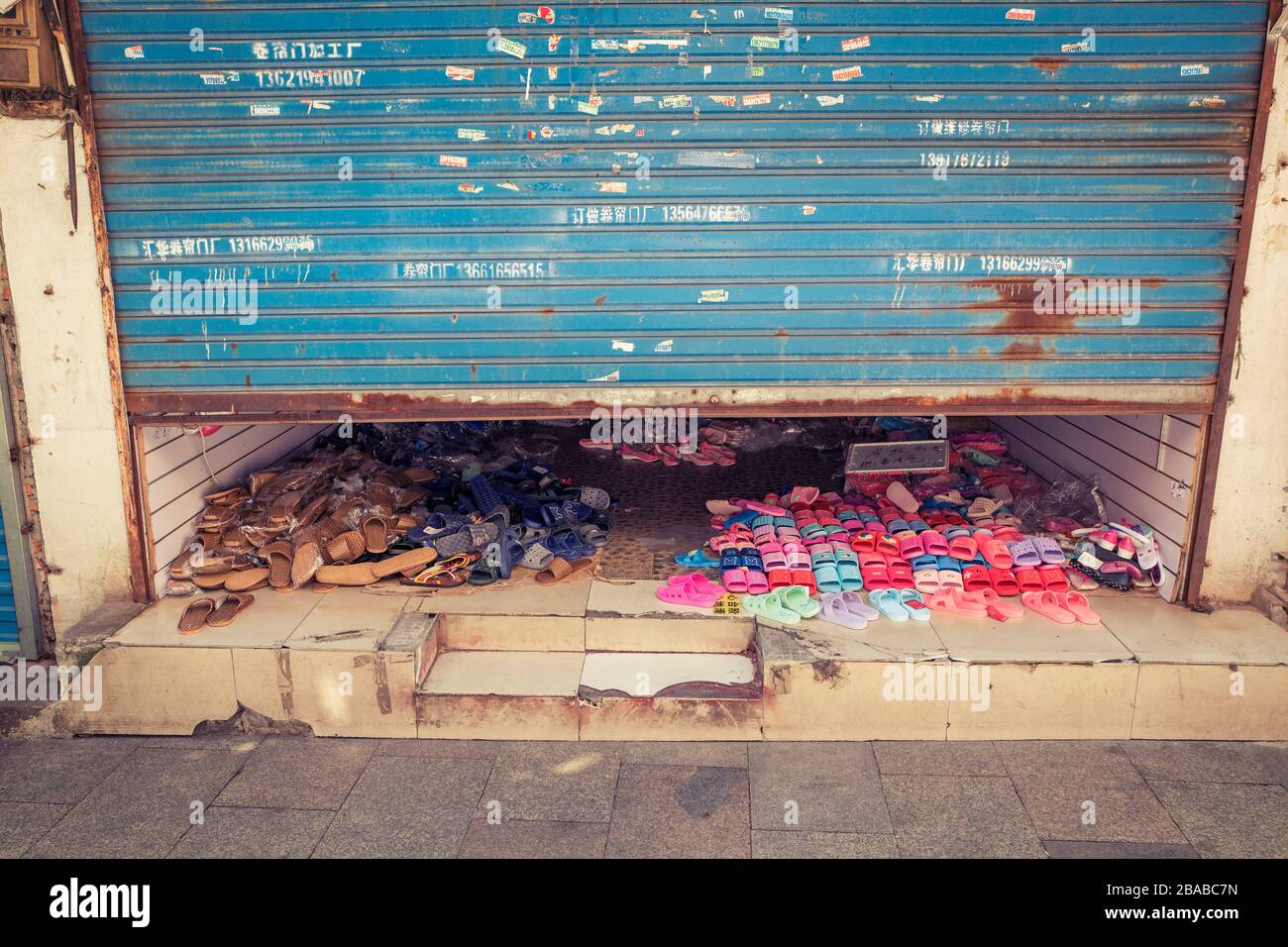 Half closed store full of sandals Stock Photo - Alamy