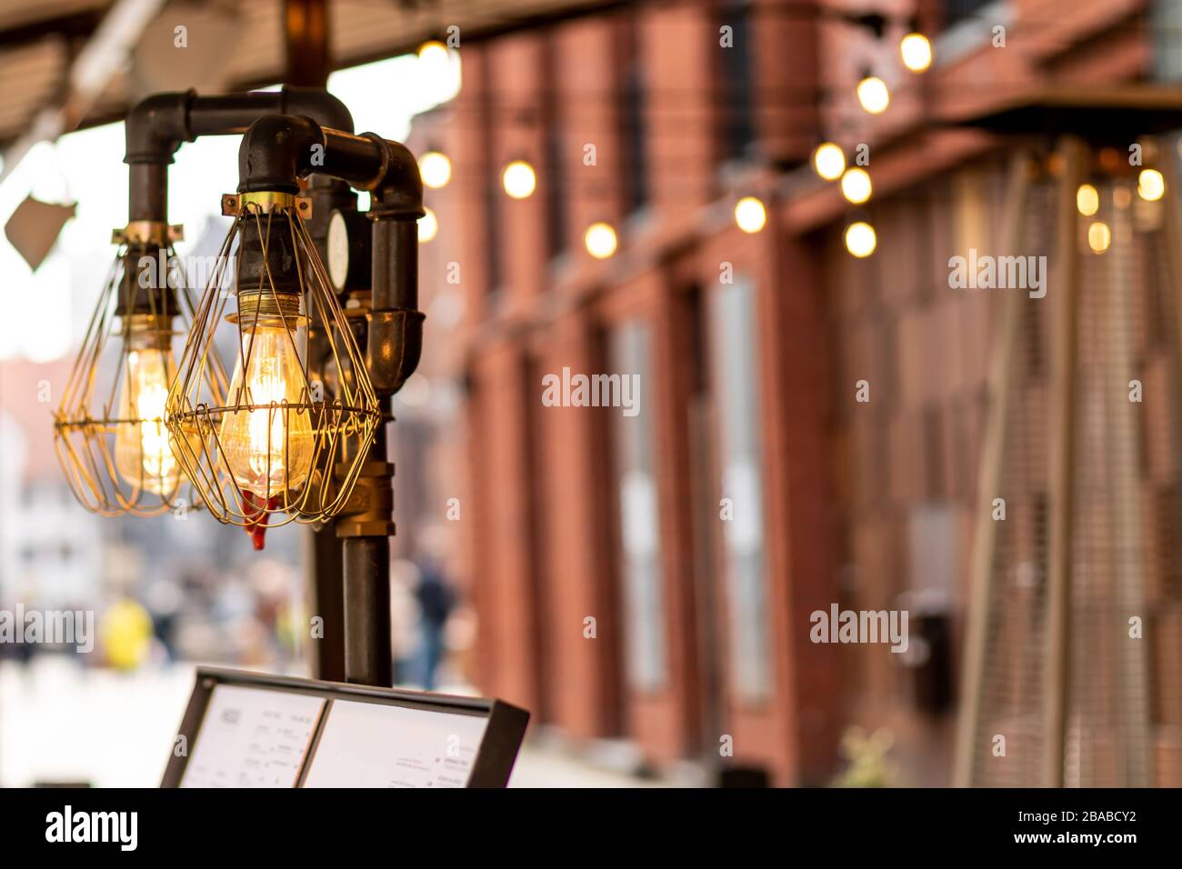 Modern lamp from metal with Edison bulb in outside restaurant cafe ...