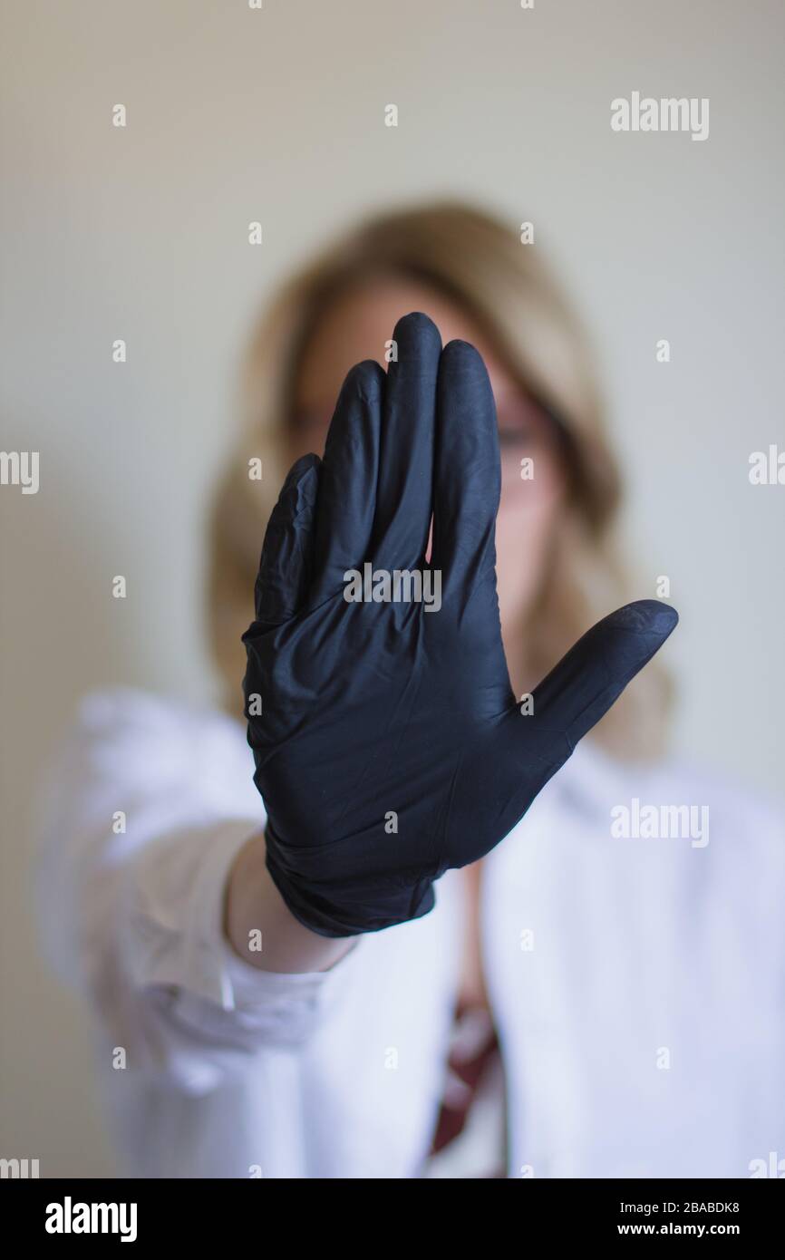 Woman Showing Stop Sign with Hand in Glove Stock Photo - Alamy
