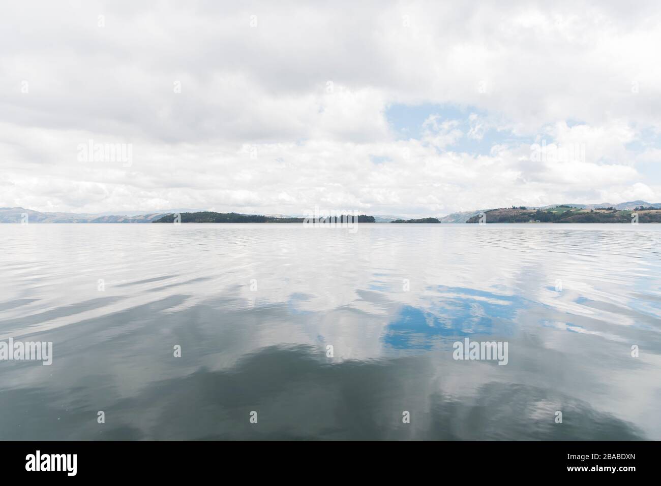 Tota lake, calm landscape, cloudy sky reflected in the water surface ...