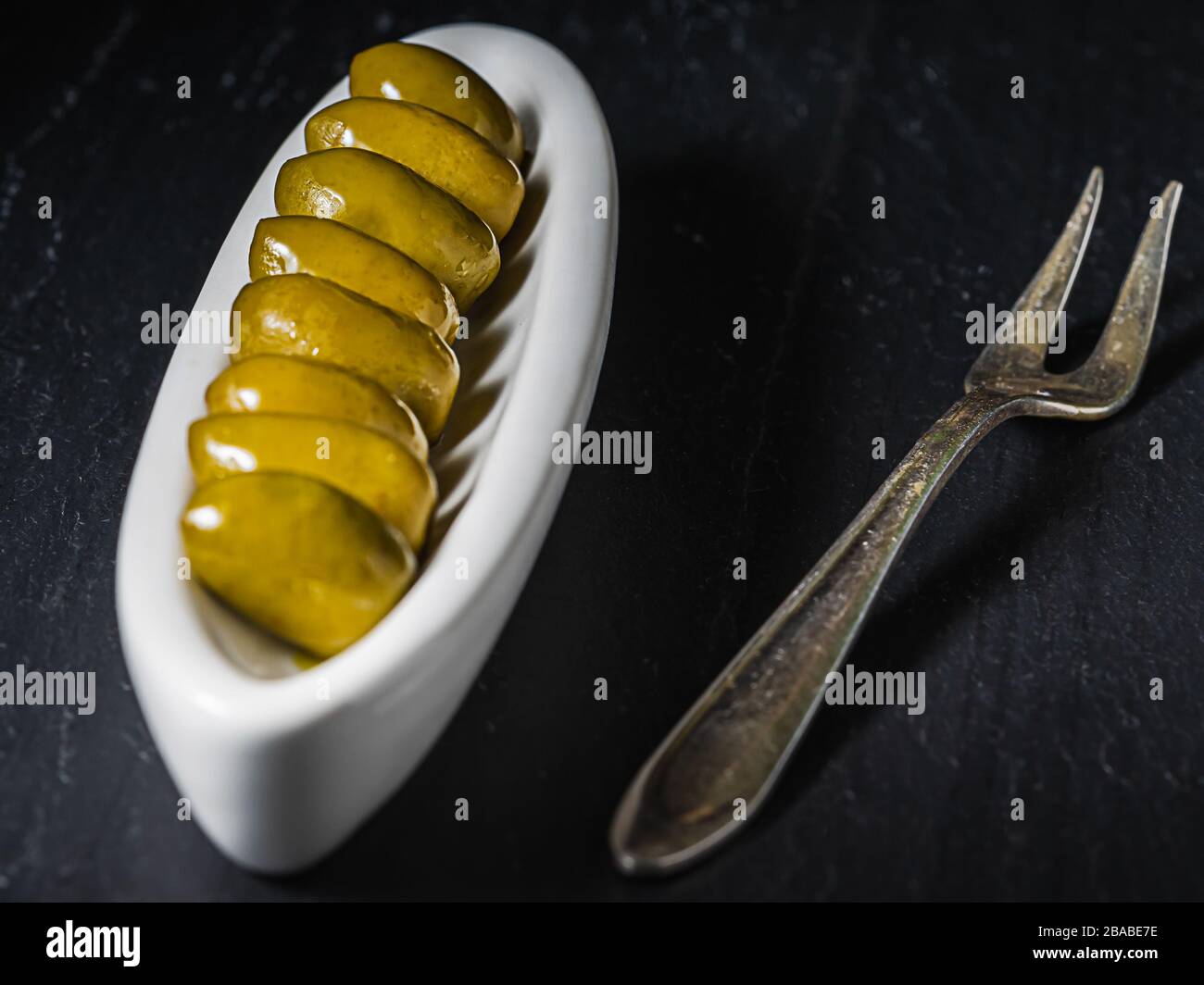 Green olives in serving dish Stock Photo - Alamy