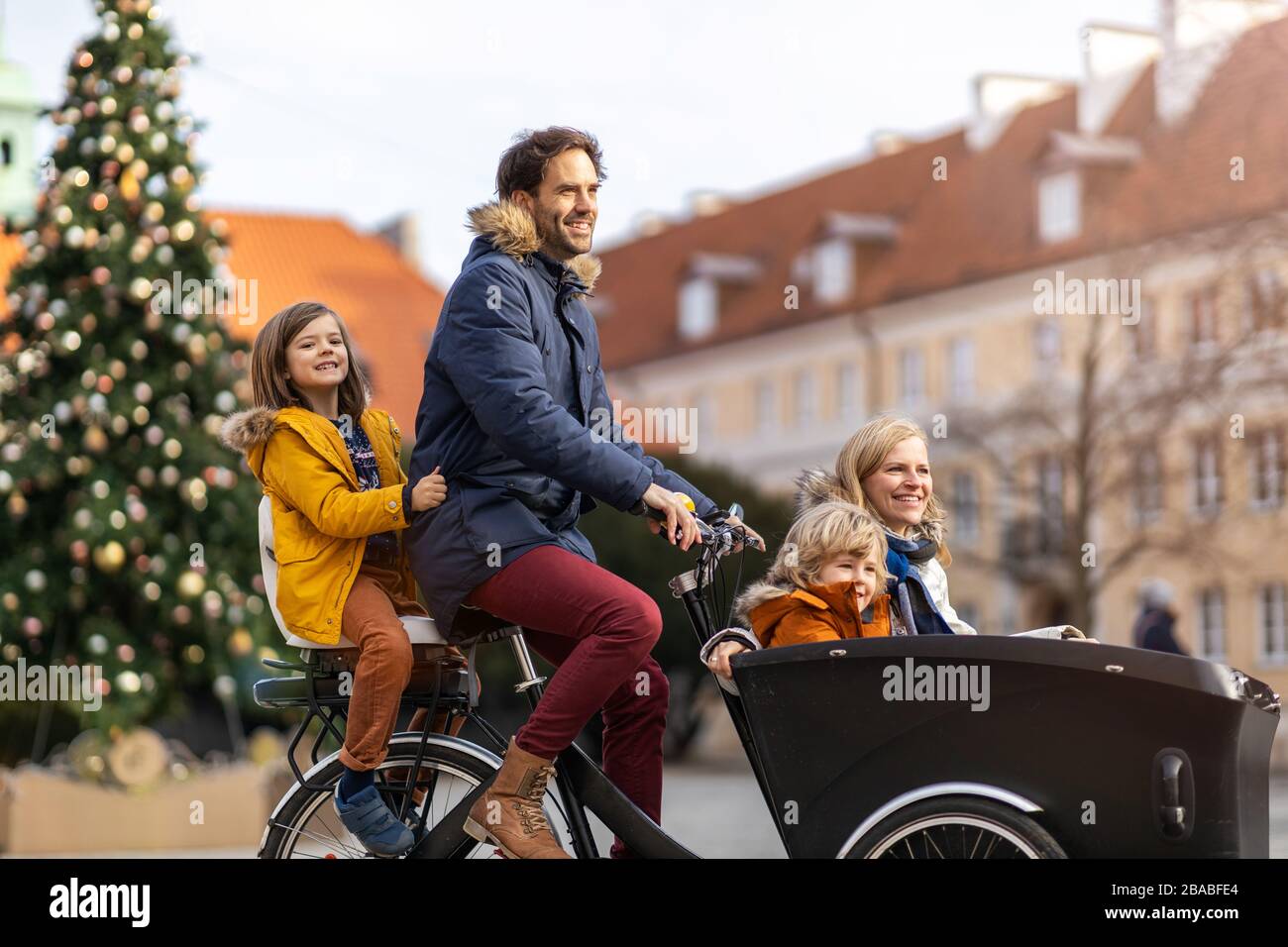 Young family riding in a cargo bicycle together Stock Photo - Alamy
