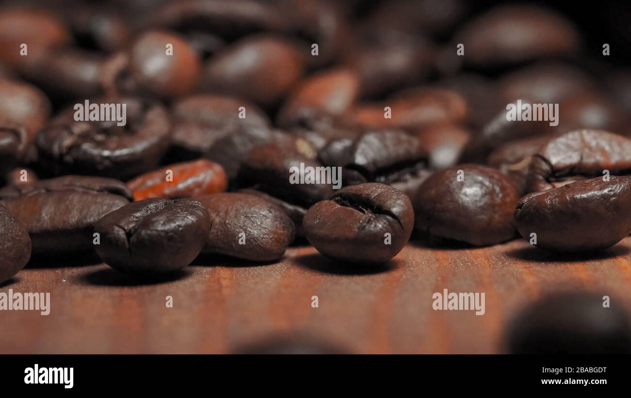 Closeup of Roasted brown coffee beans lye on the table, front view ...