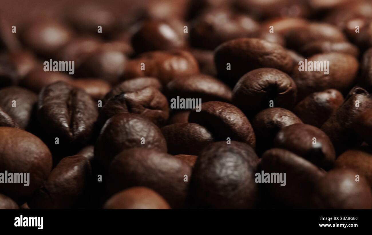 Closeup of Roasted brown coffee beans lye on the table, front view ...