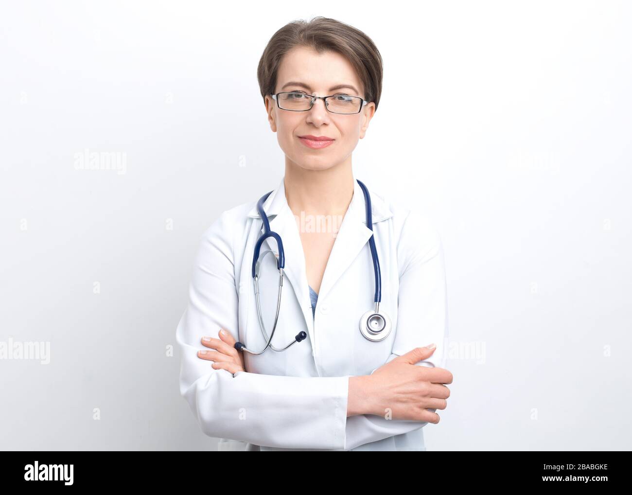 Portrait of a smiling female doctor in lab coat with a stethoscope on a ...