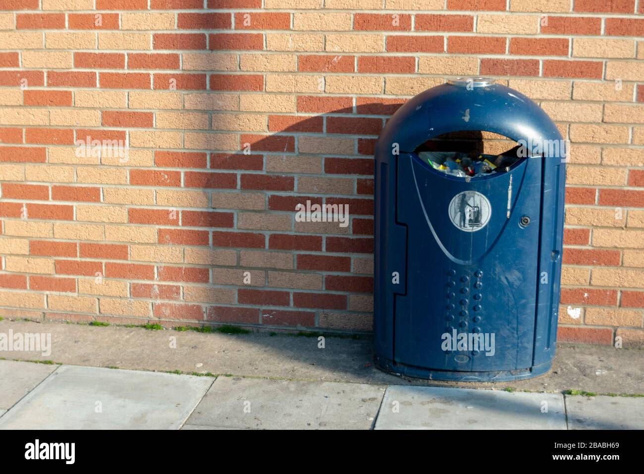 a close up view of a blue public dustbin outisde a supermarket Stock ...