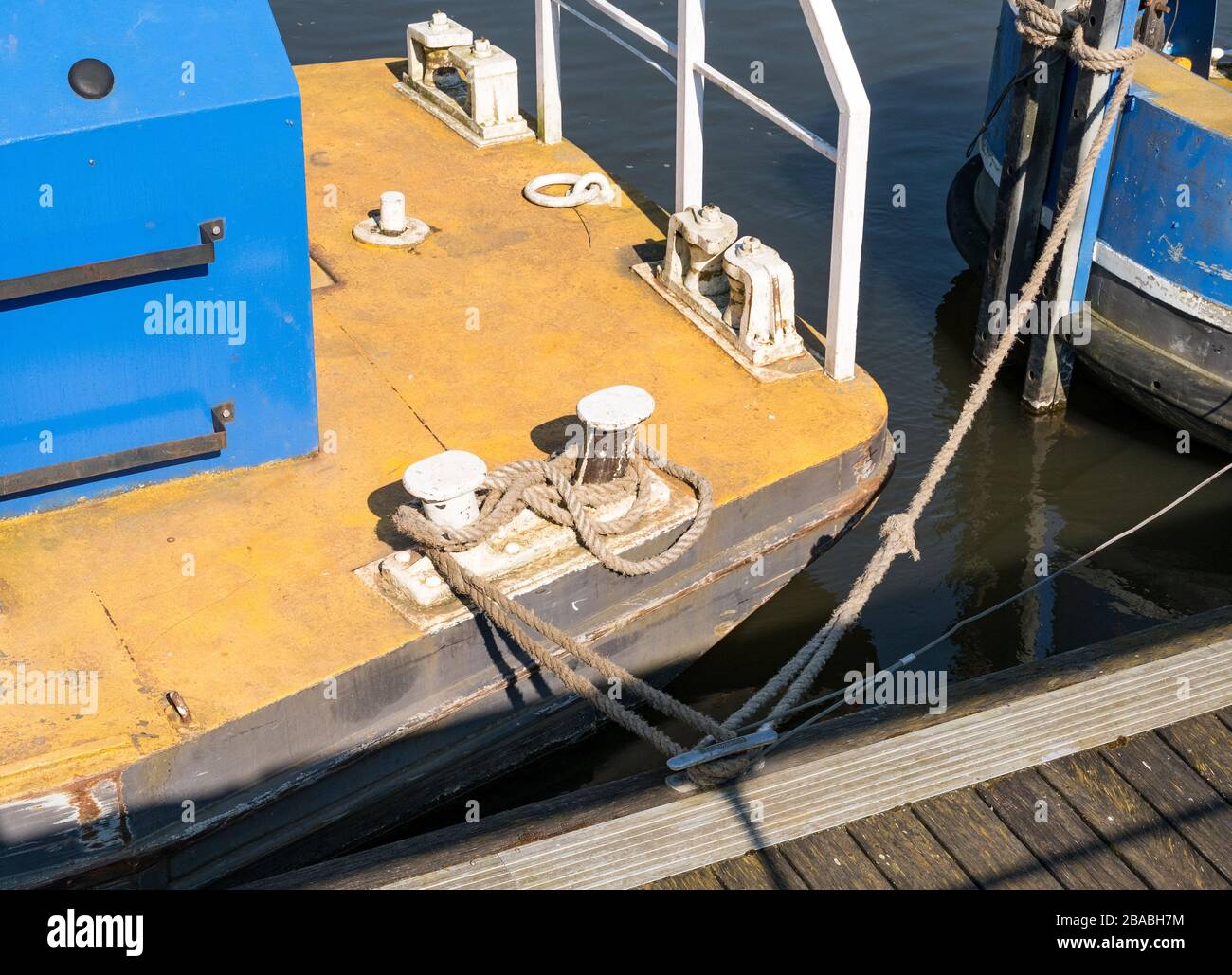 Work barges moored end to end Stock Photo - Alamy