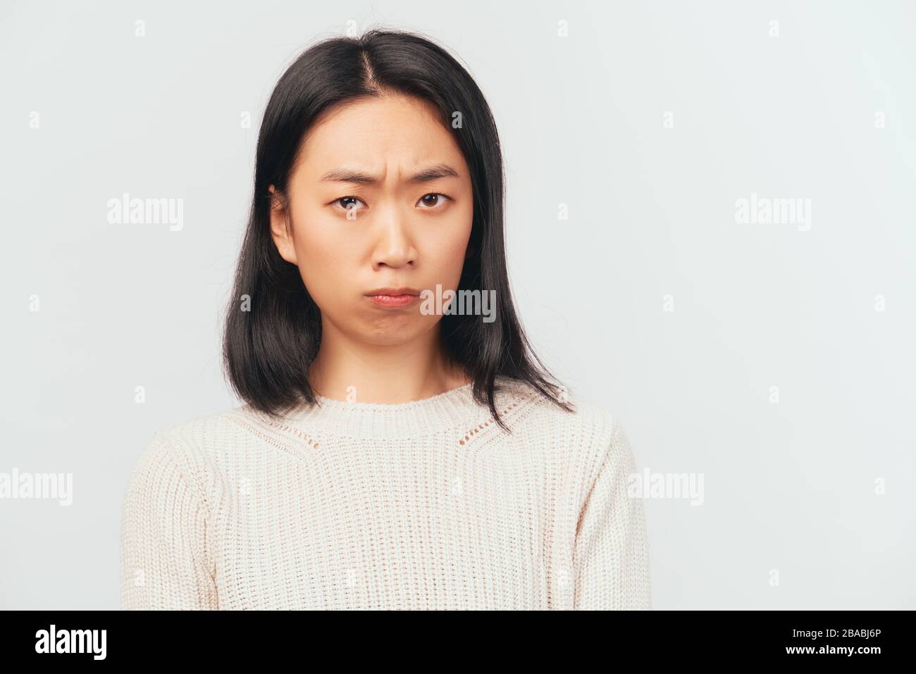Discontent female curving her lips, grumpy angry Stock Photo - Alamy