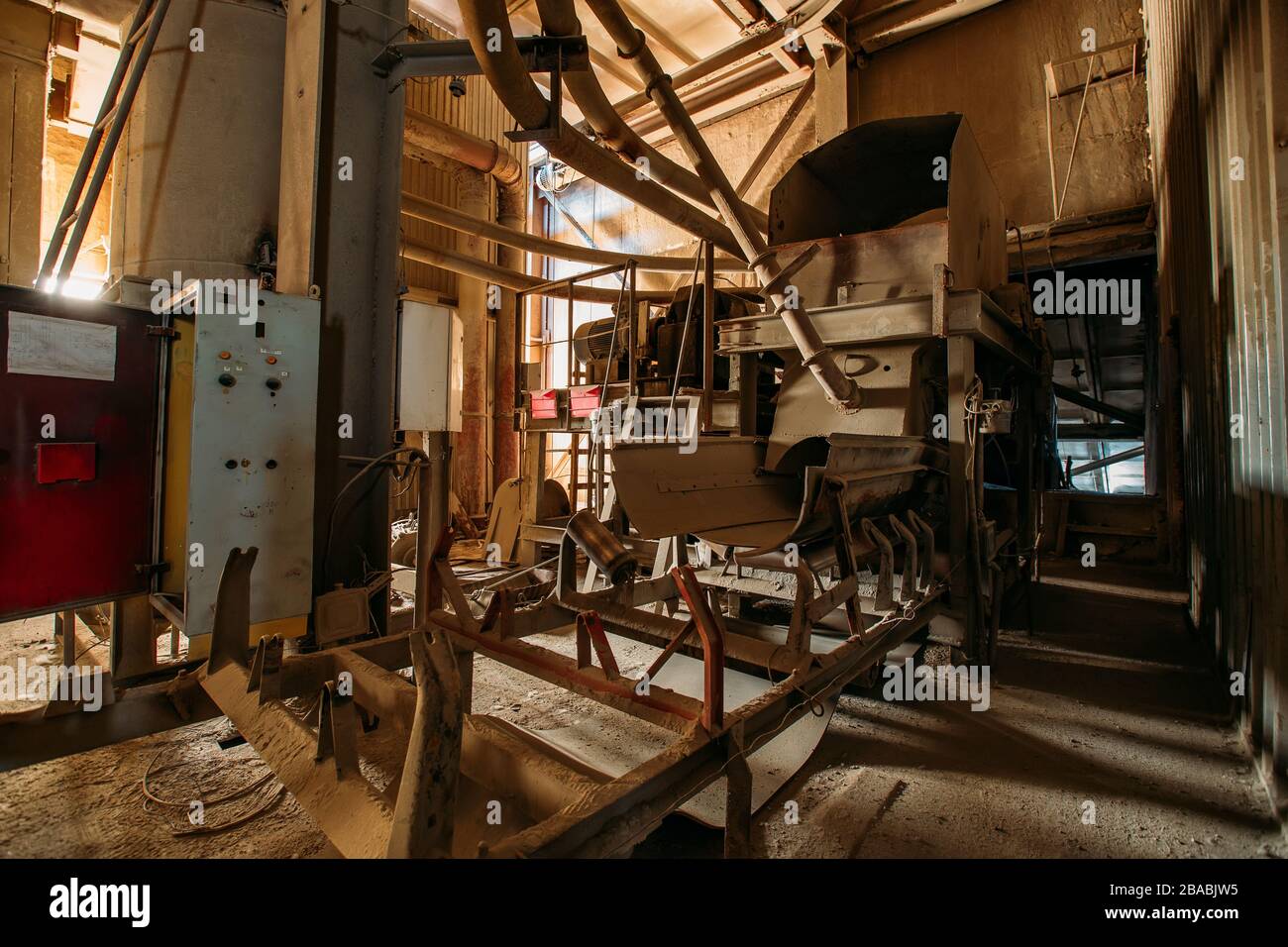 Old dirty dusty abandoned cement factory with remnant of equipment ...