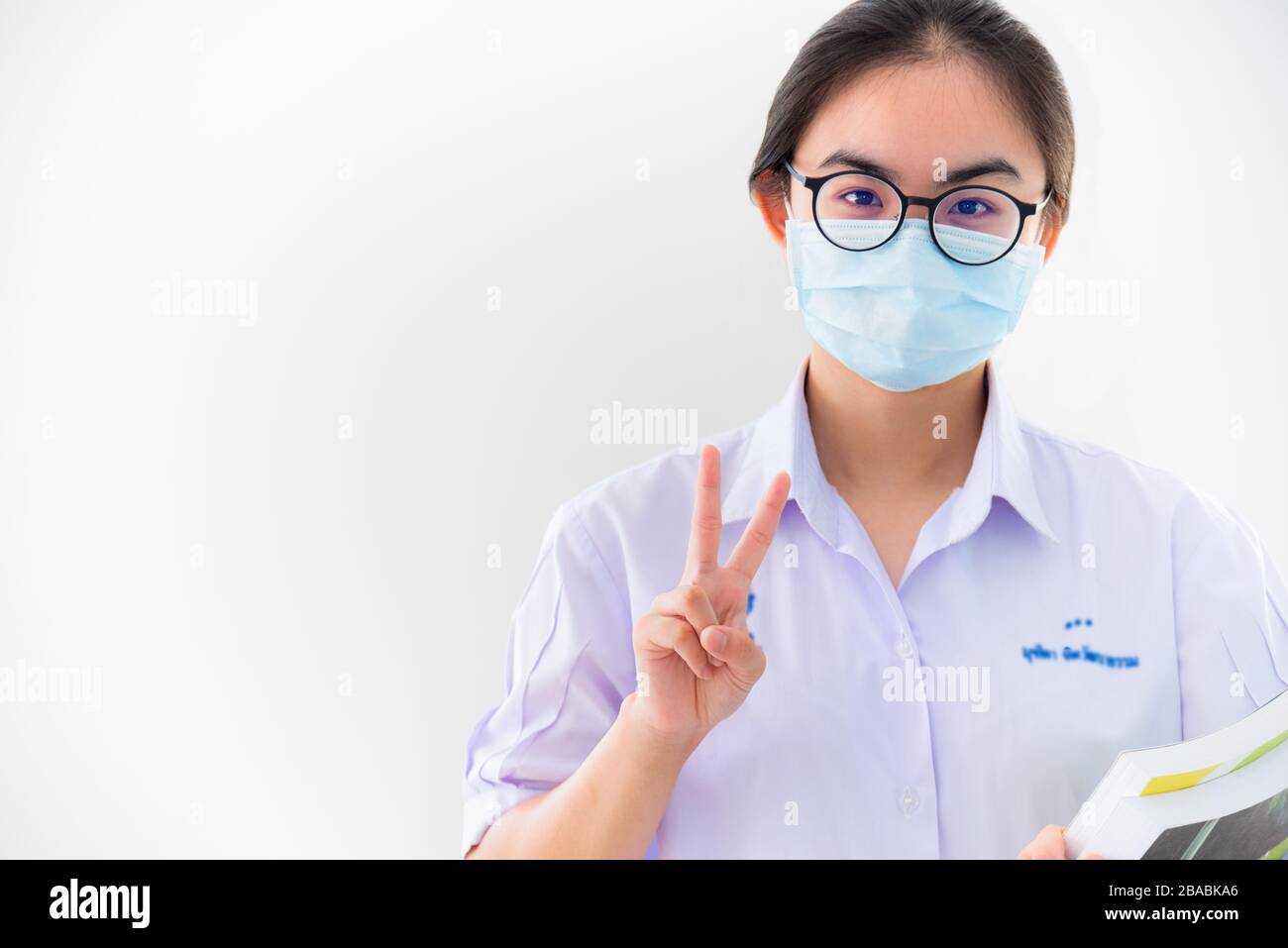 Student Asian young woman wears a mask to protect Coronavirus spread ...