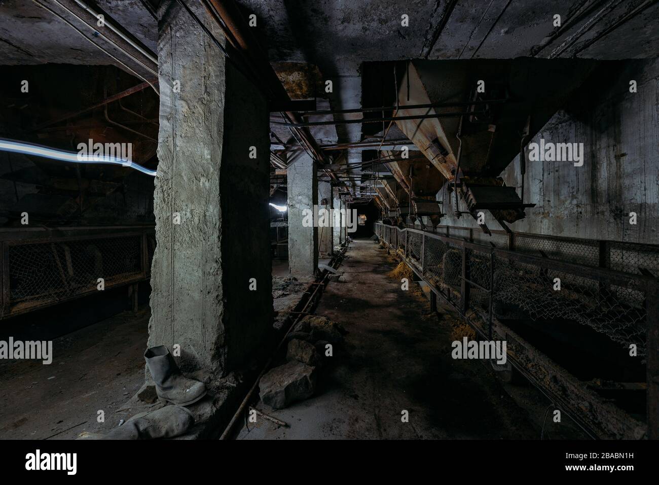 Abandoned cement and concrete factory. Old conveyor and rusty hoppers ...