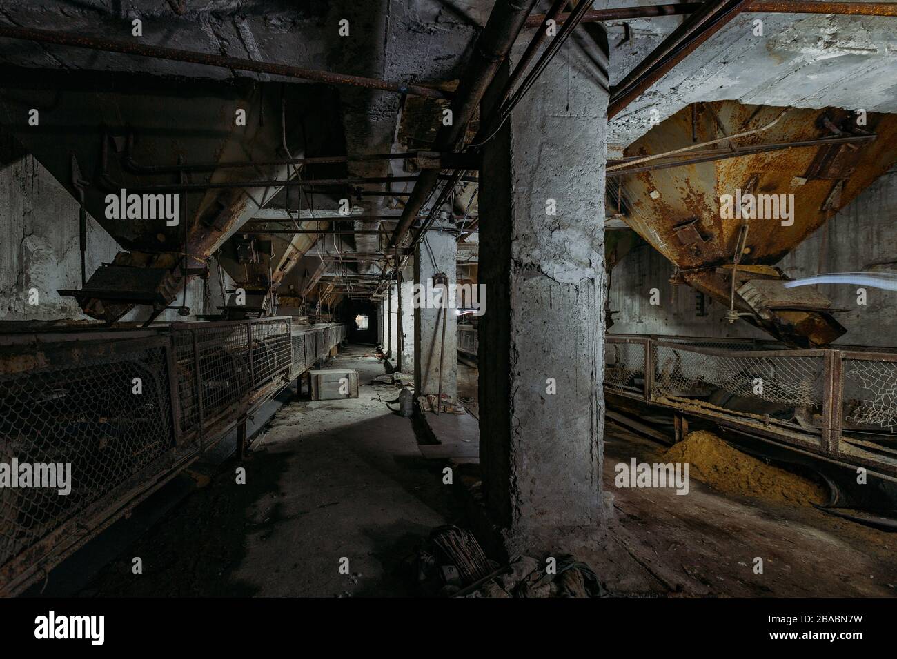 Abandoned cement and concrete factory. Old conveyor and rusty hoppers ...
