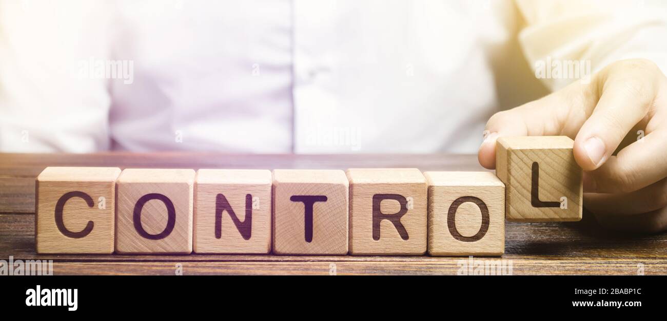 A man makes the word Control out of blocks. Business process management ...