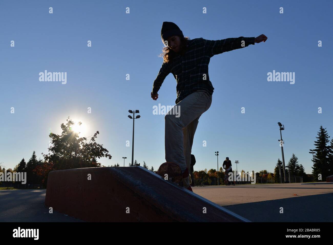 Silhouette of a boy skateboarding in the skatepark Stock Photo - Alamy