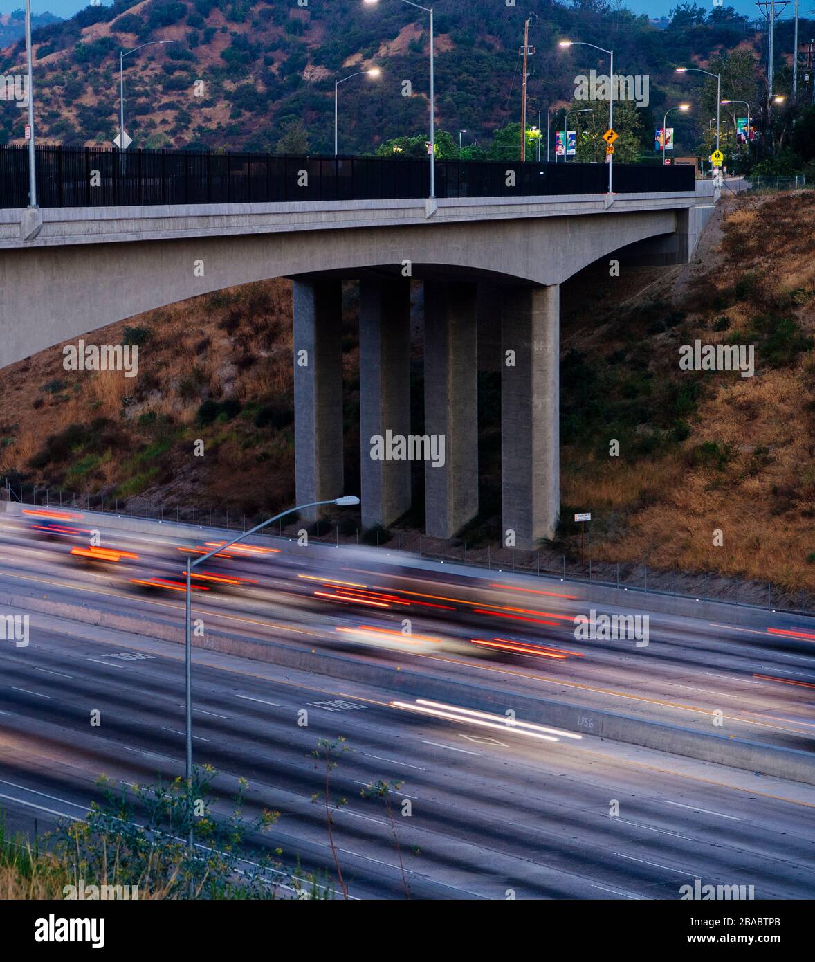View of bridge over freeway overpass at night on Los Angeles ...