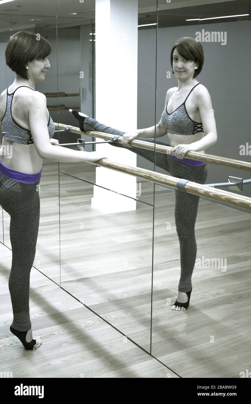 Female dancer doing leg stretches on the ballet barre Stock Photo - Alamy