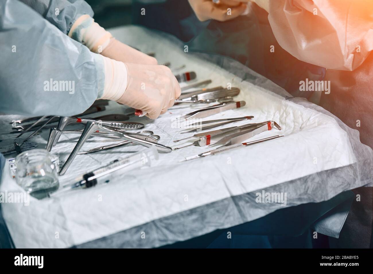 The surgeon's hands are holding an operating tool in the operating room ...