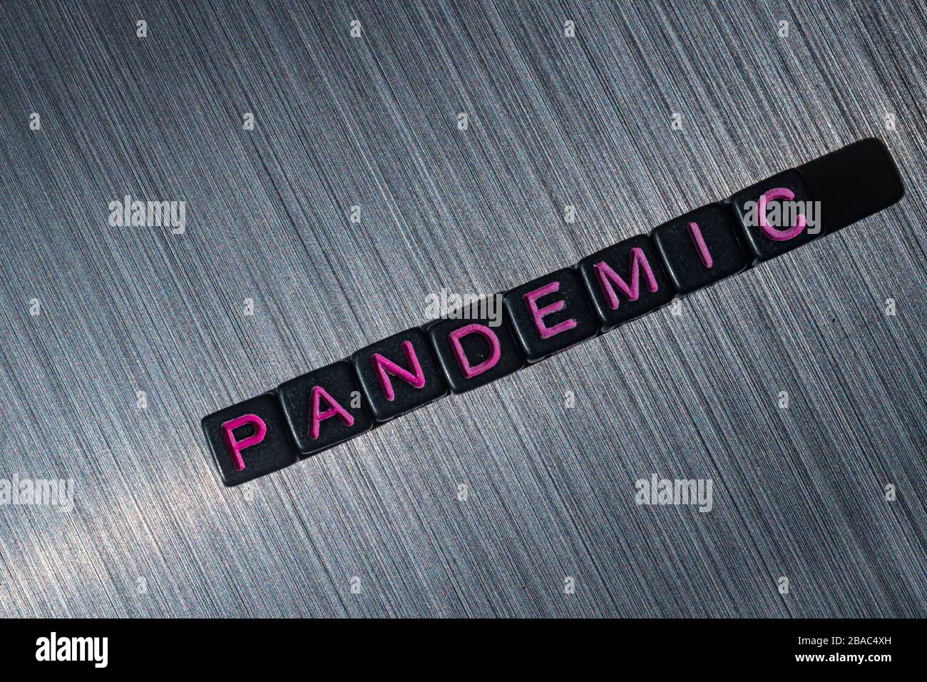 Pandemic text on brushed metal texture background Stock Photo - Alamy