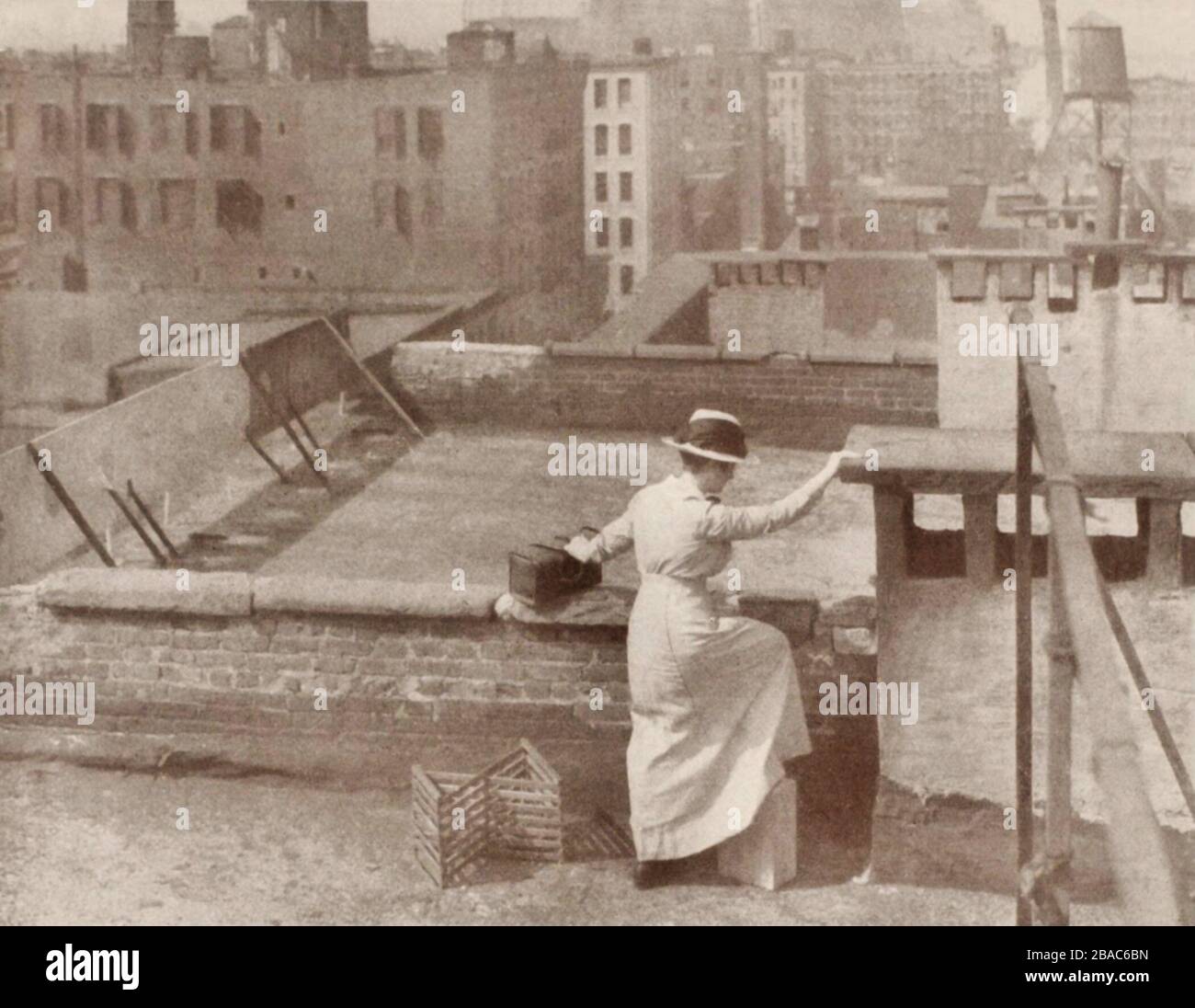 A Public Health visiting nurse takes a short cut over a tenement roof ...