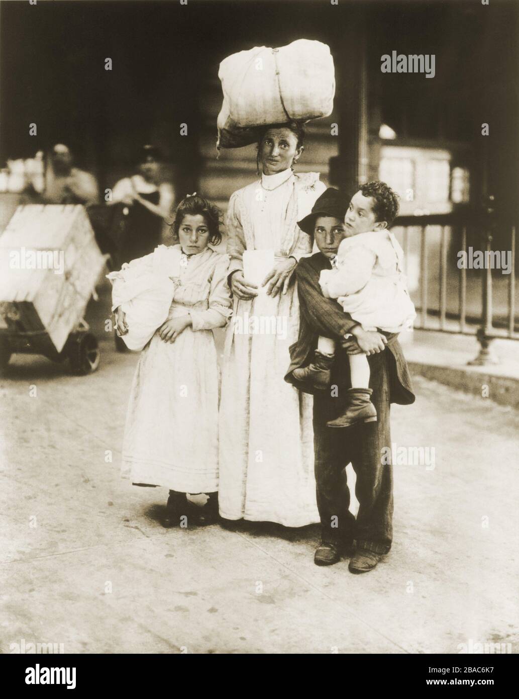 Italian immigrant family at Ellis Island, c. 1910. The mother with ...