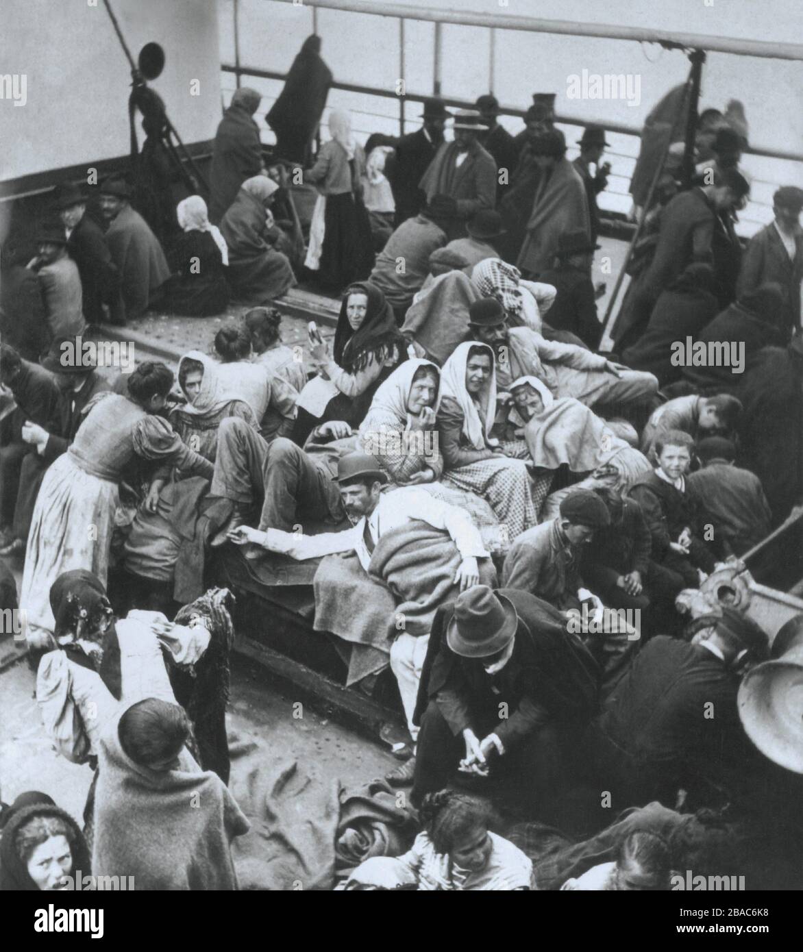 European immigrants huddled on the deck of a passenger ship sailing to ...