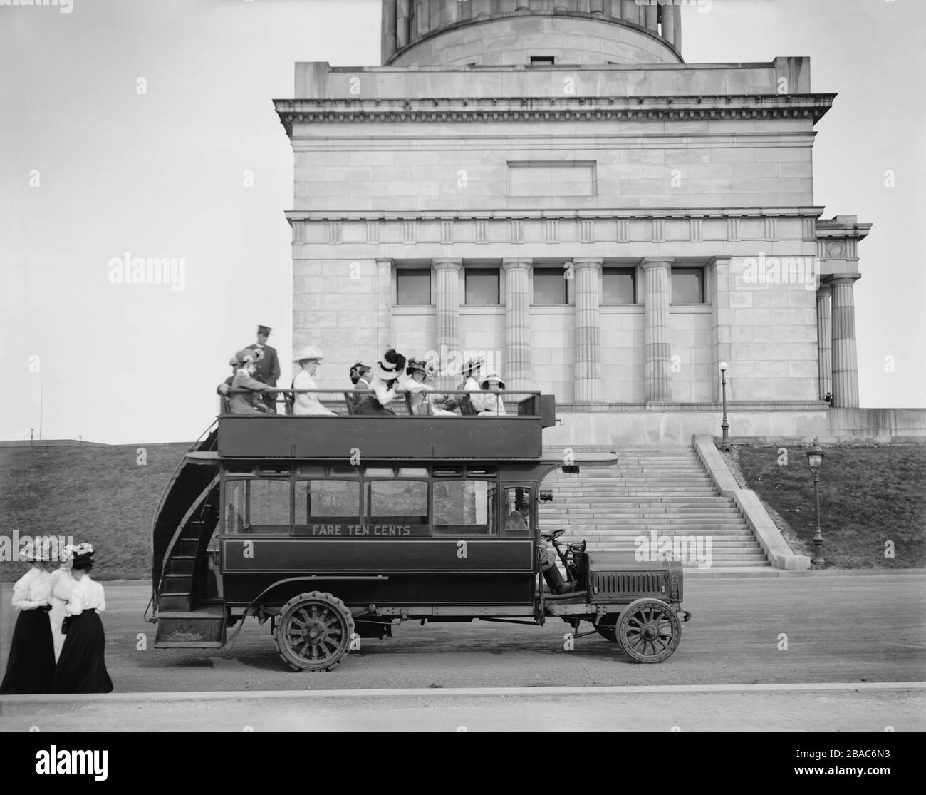 Enclosed tourist bus with open rooftop seating stops at Ulysses S ...