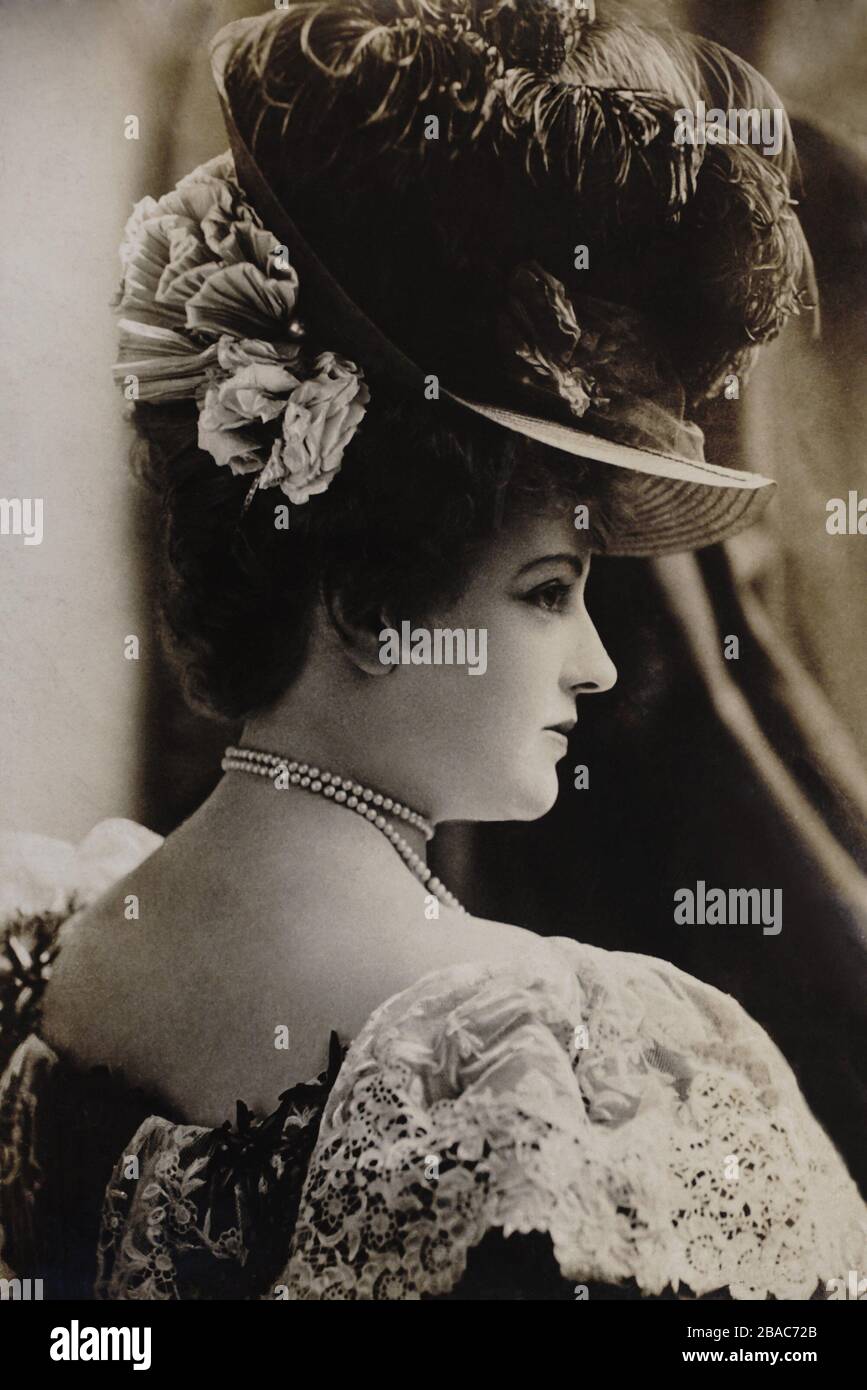 Actress Lillian Russell wears an elaborate ostrich feather hat, pearls ...