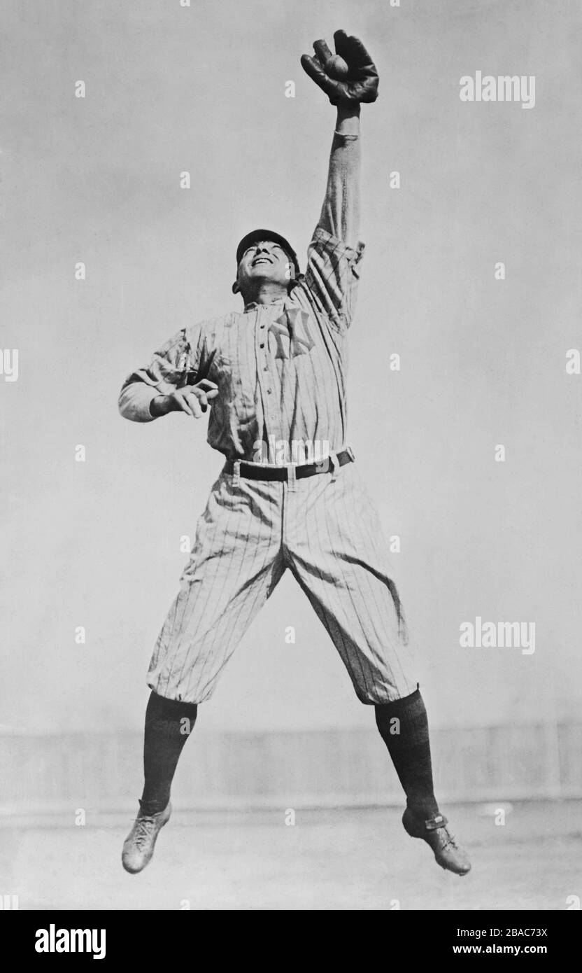 Frank 'Home Run' Baker, in a New York Yankees uniform, reaching to ...