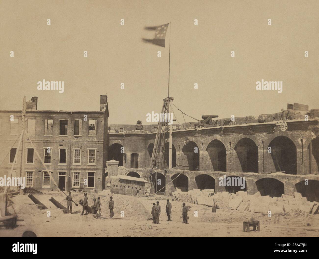 Confederate flag flying over the ruins of Fort Sumter after its ...