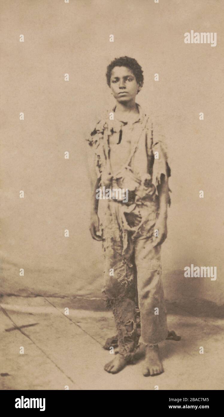 Young African American refugee, wearing rags from his place of ...