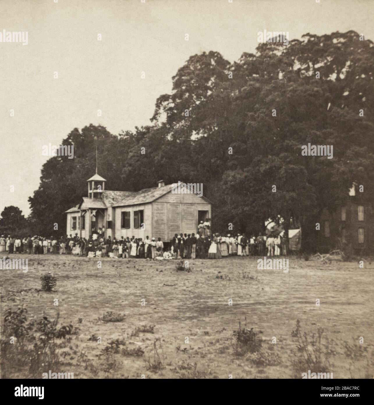 Freedmen and their children in front of Miss Laura Towne's school, St ...