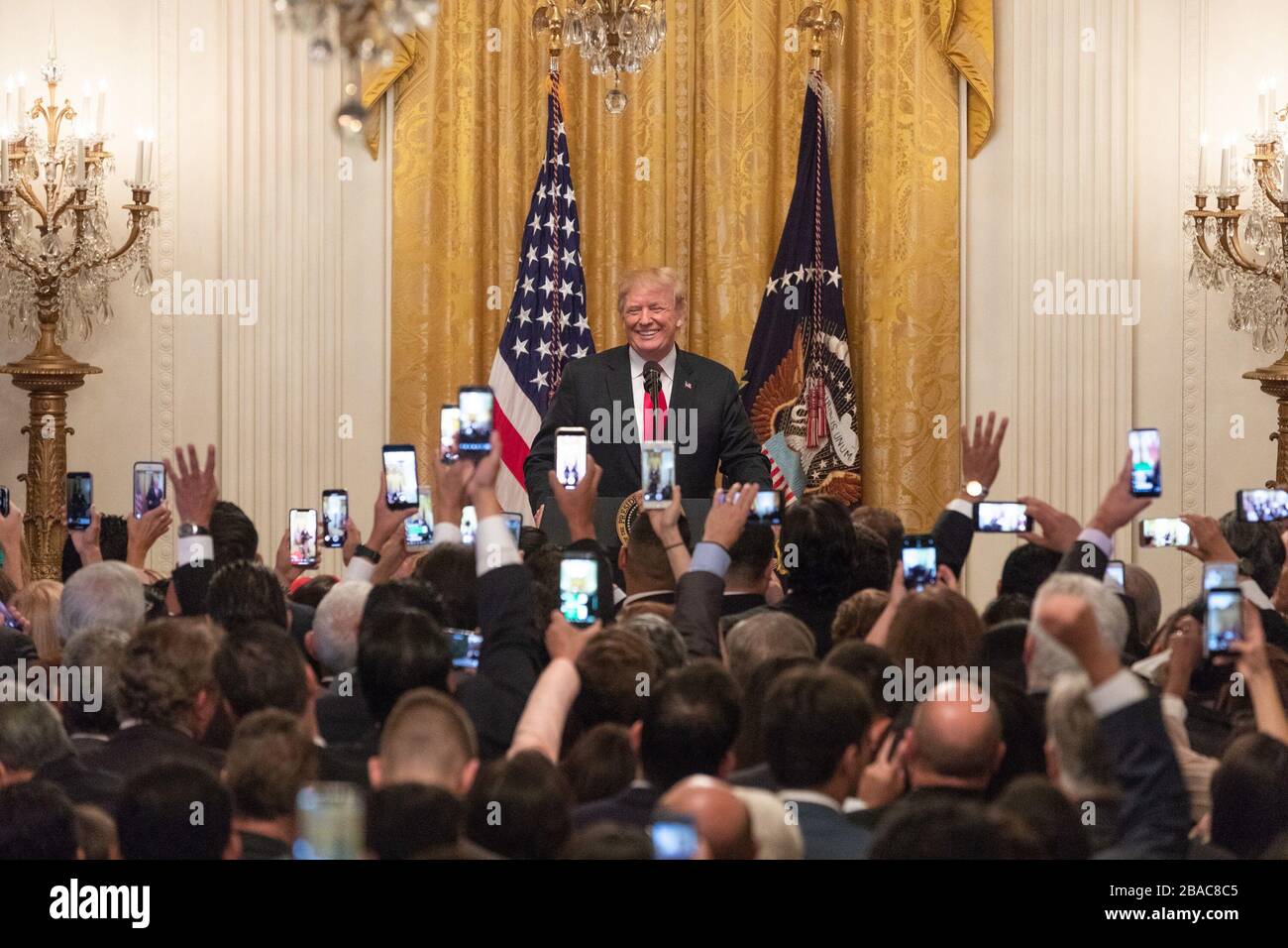President Donald Trump, smiles for photo by guests at a Hispanic ...