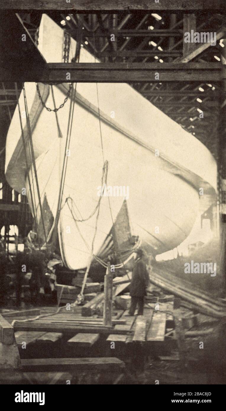 Ship designer, John Ericsson, posing by the hull of the Monitor ...