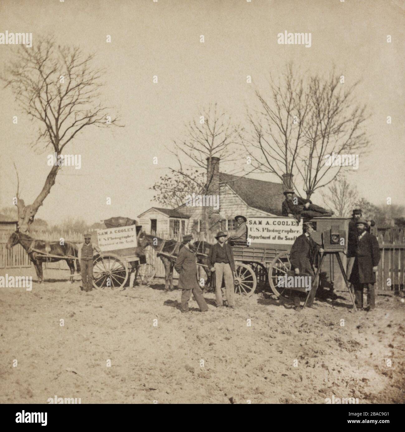 A group of men stand next to wagons labeled 'Sam A. Cooley U.S ...