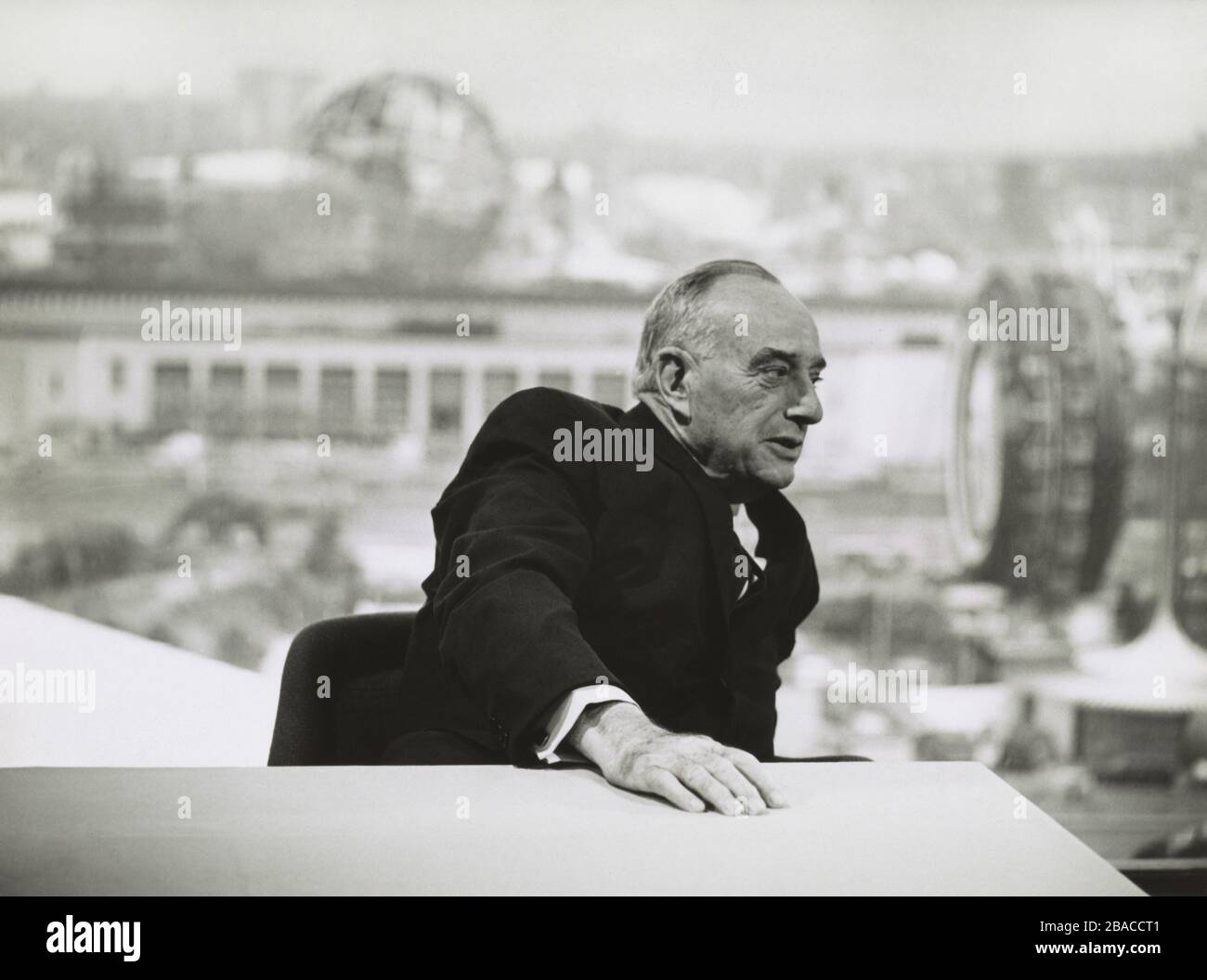 Robert Moses in 1964, seated at a table with a view of the New York ...