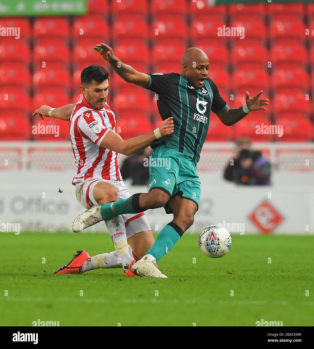 Stoke City's Danny Batth (left) fouls Swansea City's Andre Ayew Stock ...