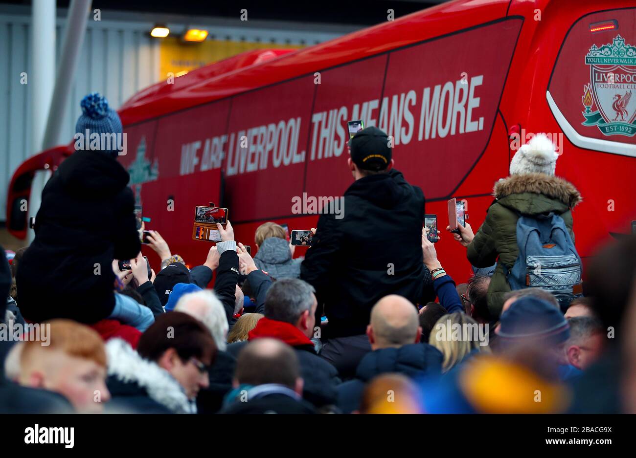 Fans gather around the Liverpool bus as it approaches the ground Stock ...