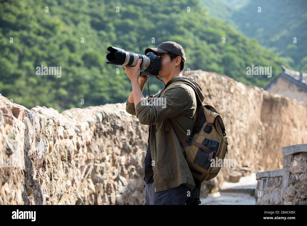 Chinese photographer taking photos in village Stock Photo - Alamy