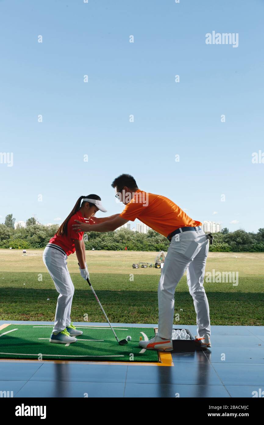 The practice field coaching girls to play golf Stock Photo - Alamy
