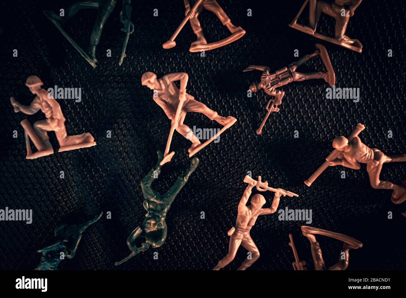 Green vs tan plastic toy army men casualties Stock Photo - Alamy