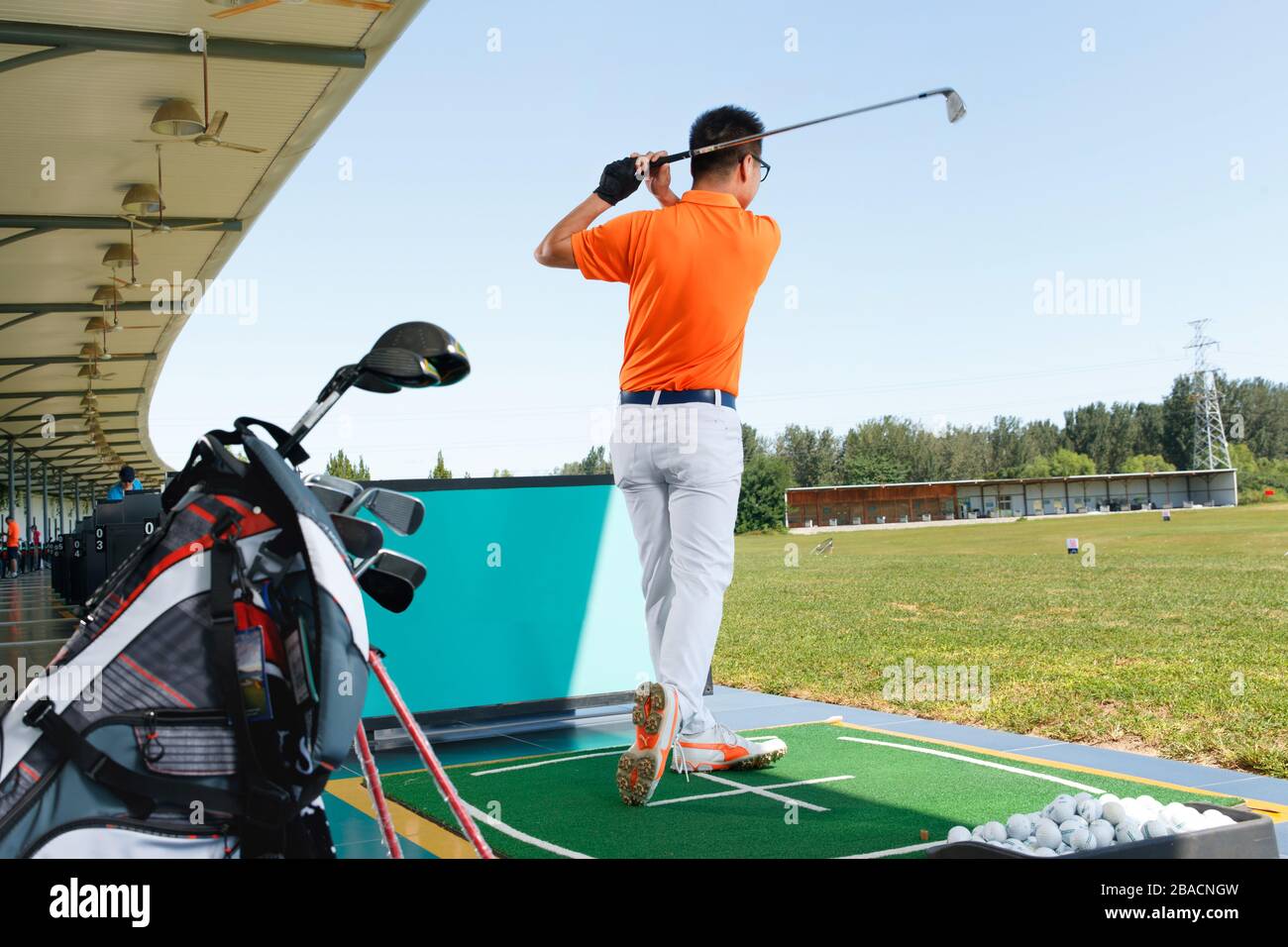 Young men playing golf Stock Photo - Alamy