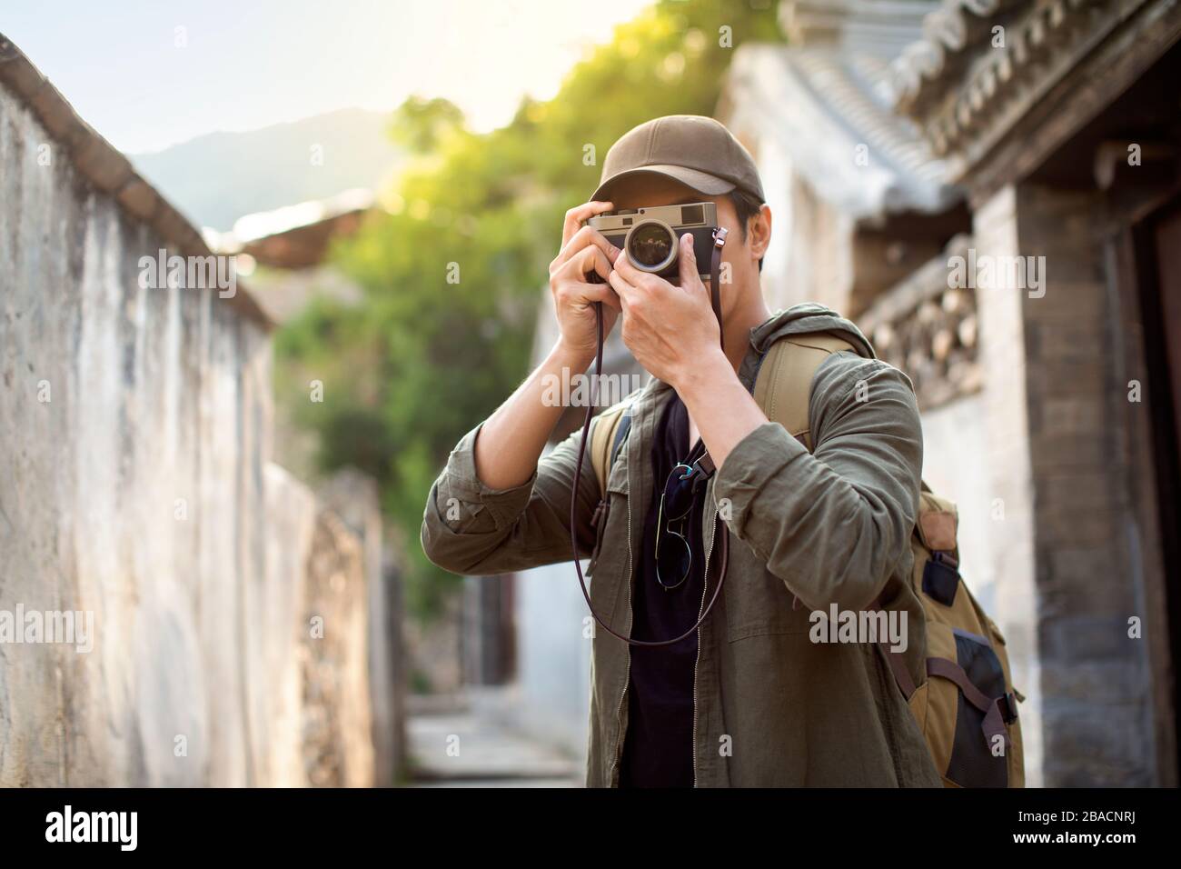 Chinese photographer taking photos in village Stock Photo - Alamy